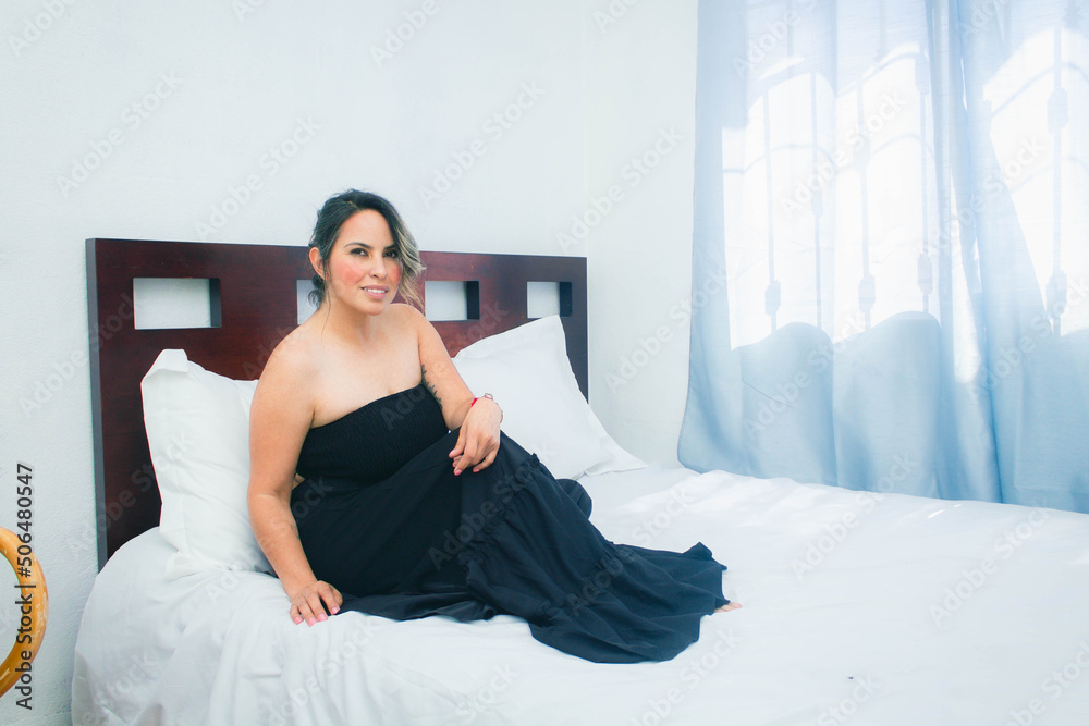 beautiful relaxed mexican caucasian mature woman wearing sitting on bed ...