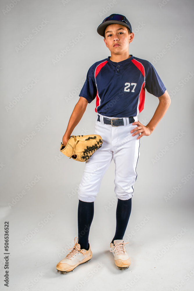 Male youth baseball player with glove standing with his hand on his hip ...