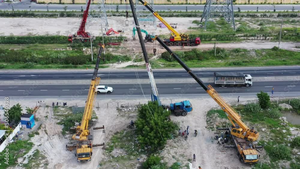 Aerial drone view of cranes and heavy machinery doing construction ...
