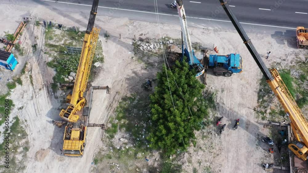 Aerial drone view of cranes and heavy machinery doing construction ...