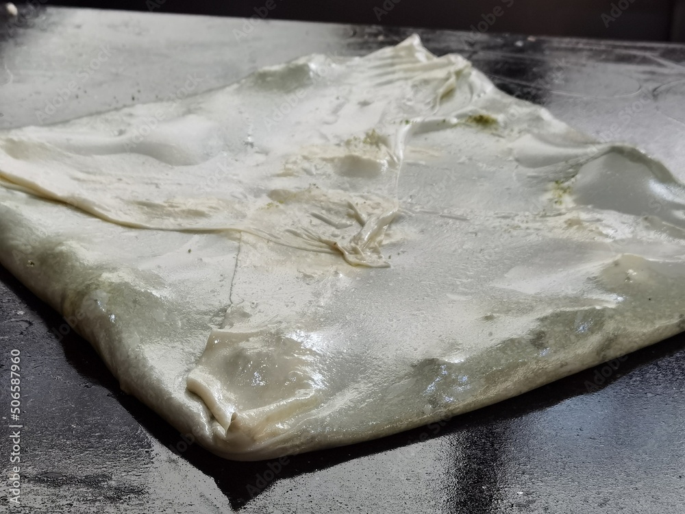 The preparation of a Turkish Katmer dessert, the content of which is ...