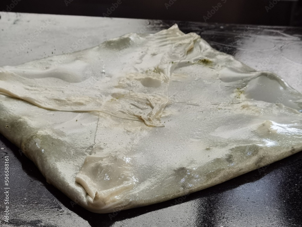 The preparation of a Turkish Katmer dessert, the content of which is ...