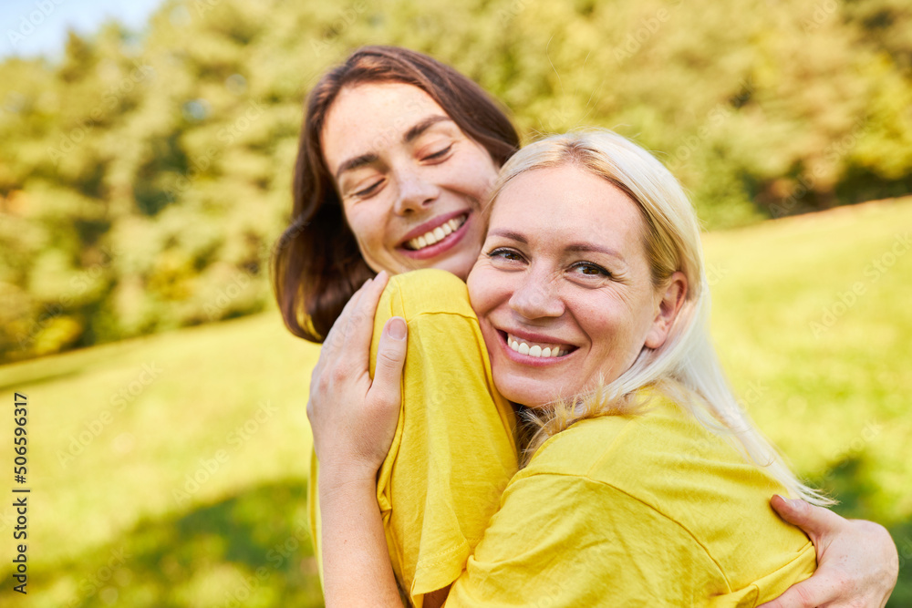 Two young girlfriends hug each other happily Stock Photo | Adobe Stock