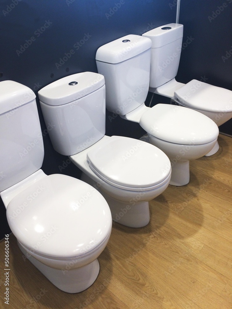 4 new white toilets seats side by side human waste bathroom design ...
