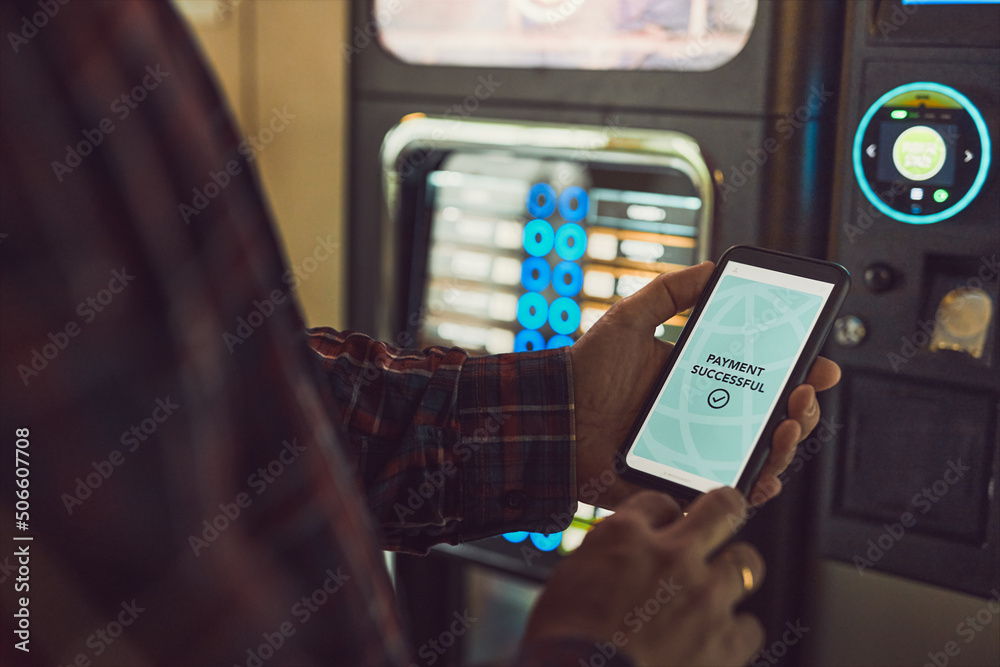 Consumer paying for product at vending machine using contactless method ...