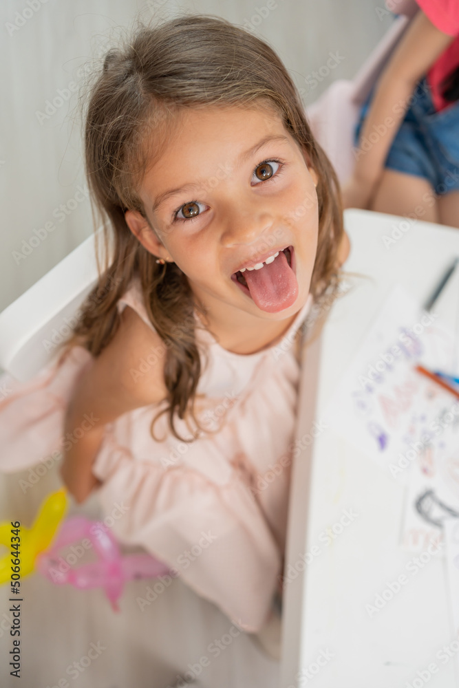 Poster Little girl smiling in coloring and drawing classroom – Wall Art ...