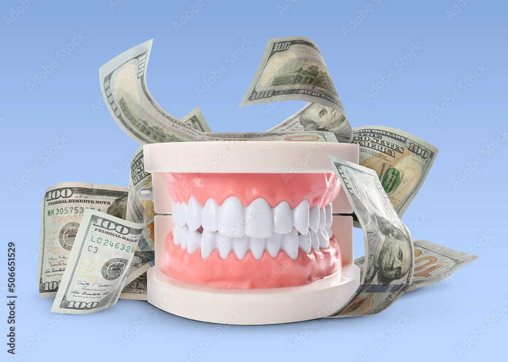 Model of oral cavity with teeth and dollar banknotes on light blue ...
