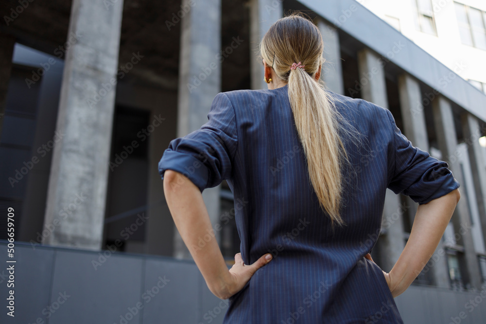 Back view of a business woman looking up at an office building Stock ...