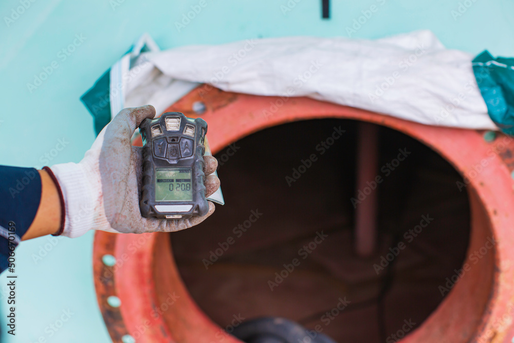 Worker hand holding gas detector inspection safety gas testing at front ...