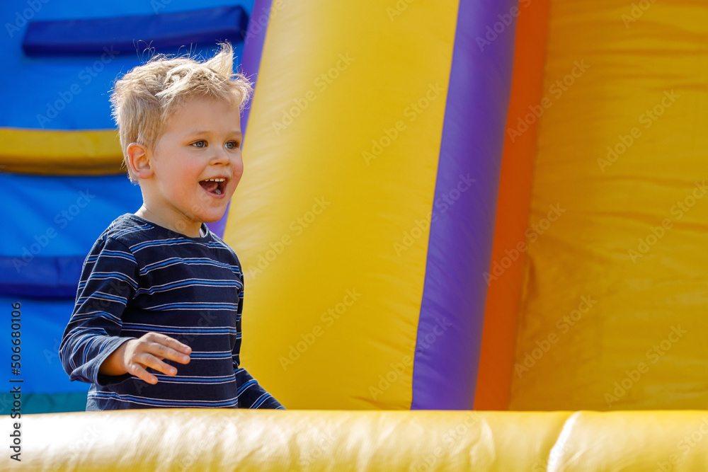 Kid jump in inflatable bounce castle on kindergarten birthday party ...