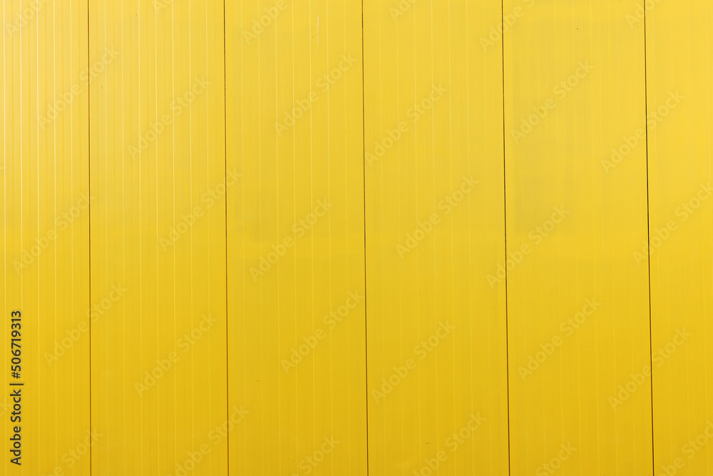 Yellow metal tile fence background. Fence from corrugated board. Yellow ...