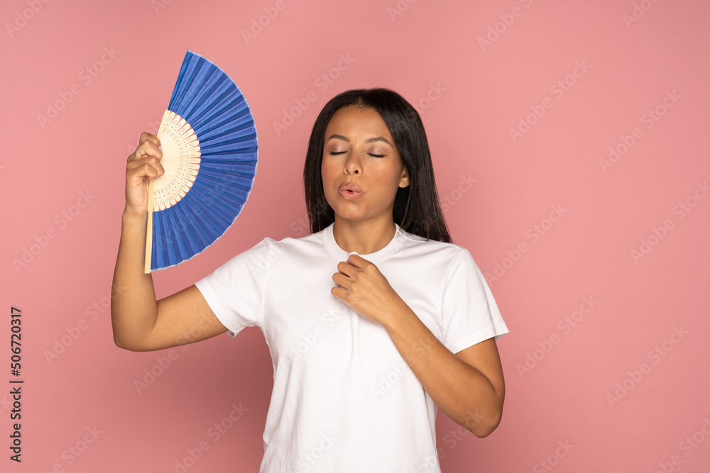 Exhausted african american woman with closed eyes using blue fan suffer ...