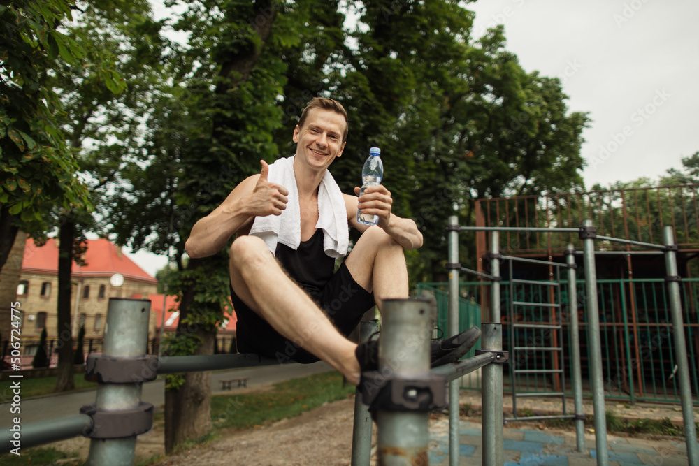 Little break. Young athletic guy with muscular body, sportsman and ...