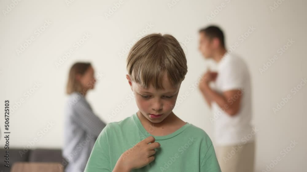 Kid son feels upset while parents fighting at background, sad little ...