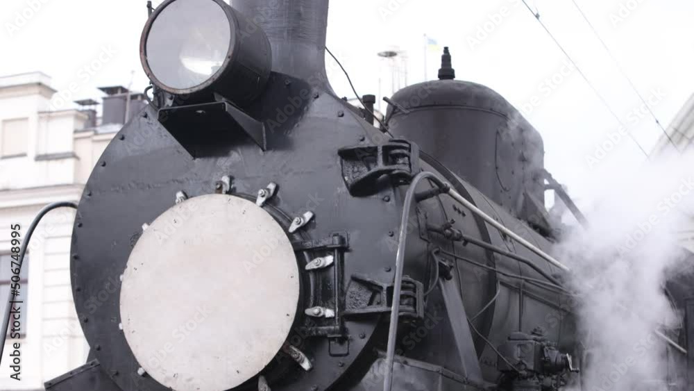 Steam locomotive train approaching station passing through goods yard ...