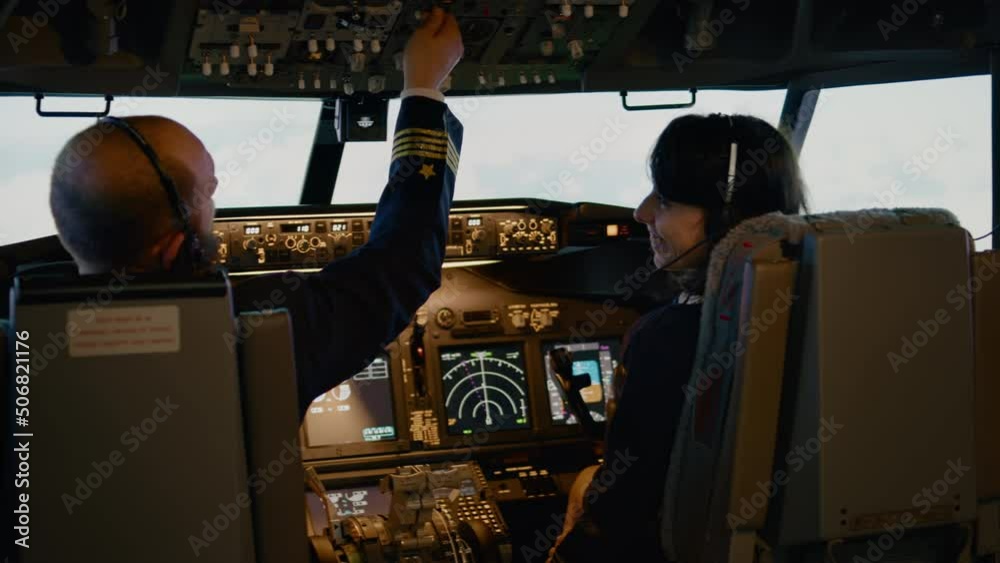 Plane captain and female copilot switching altitude and longitude level ...