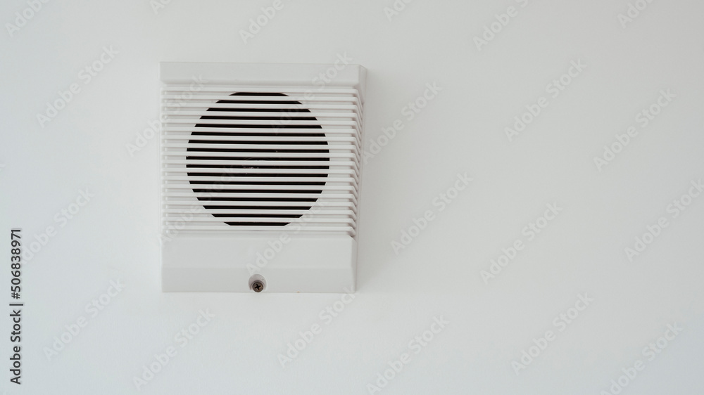 Emergency fire exit speaker for sound siren alarm on white wall. Safety ...