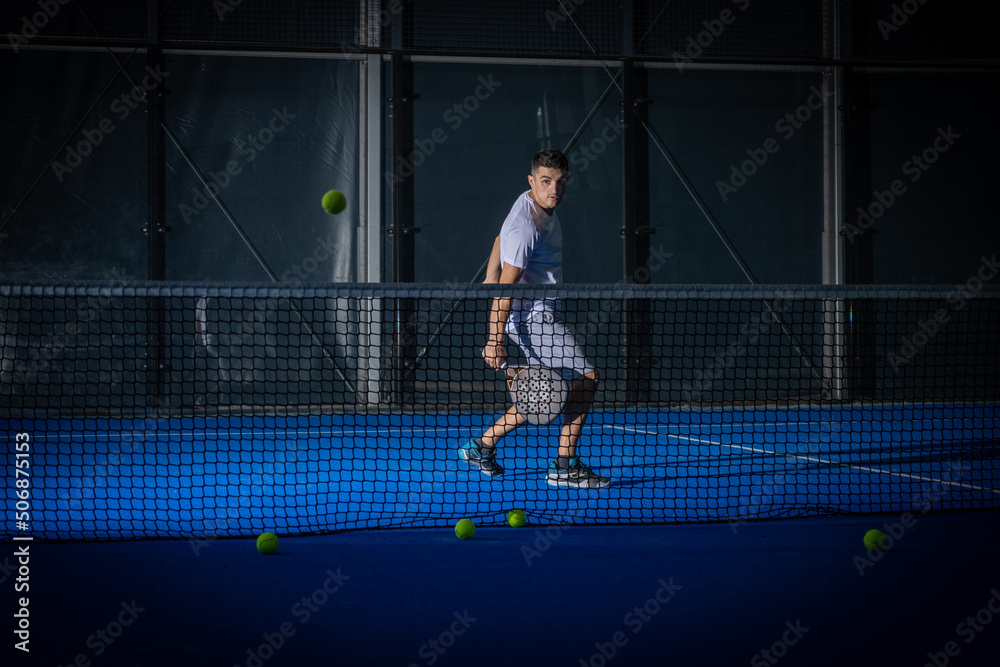 Man playing padel tennis indoor Stock Photo | Adobe Stock