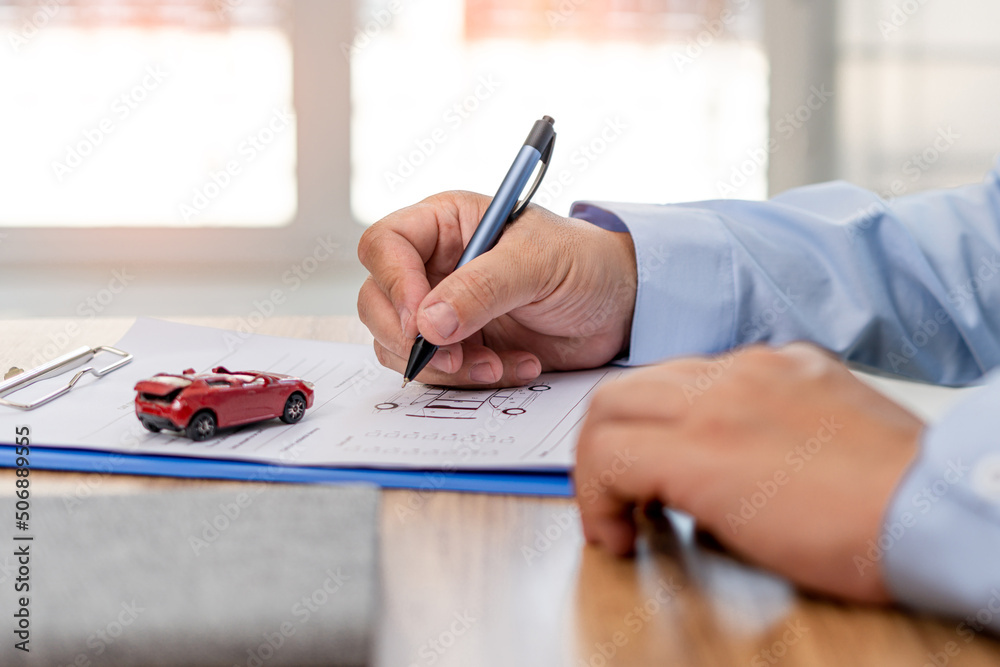 Car insurance concept: Man use pen to write insurance documents check ...