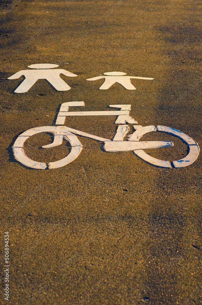 White bycicle and pedestrian symbols on a path. Pictogram imitating of ...