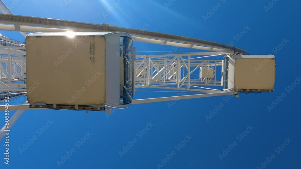 Ferris wheel booths, close view from below, ferris wheel rotating, view ...