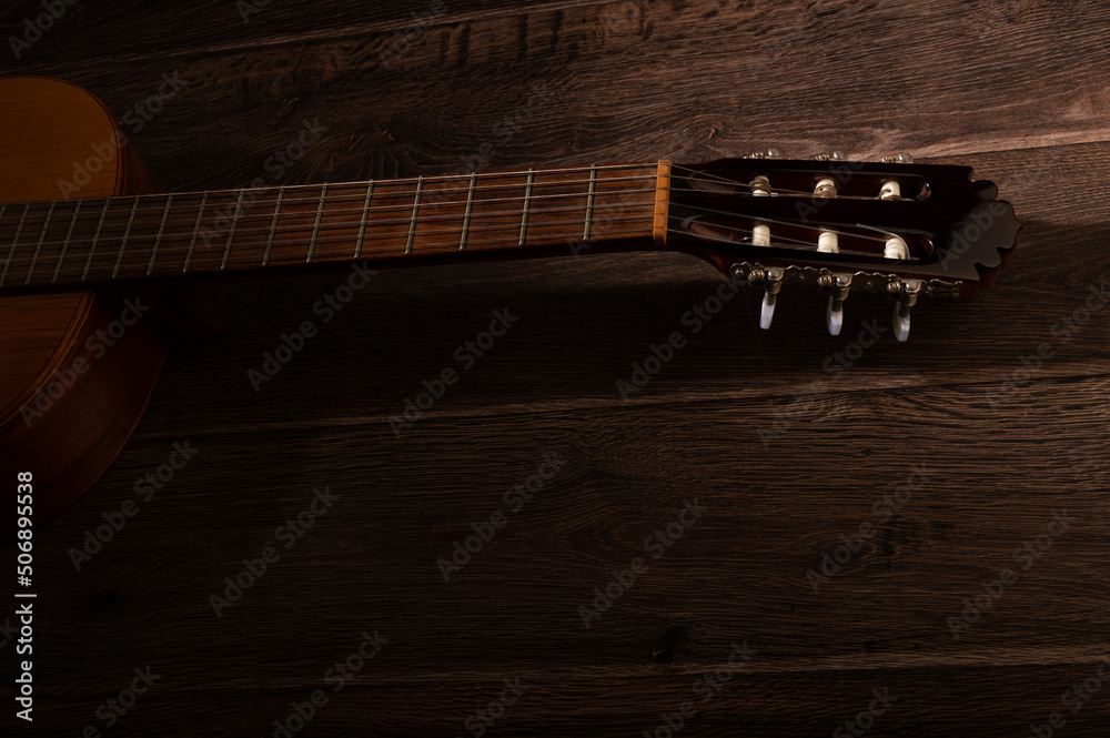 Classical guitar fretboard and machine head on dark wood with copy ...