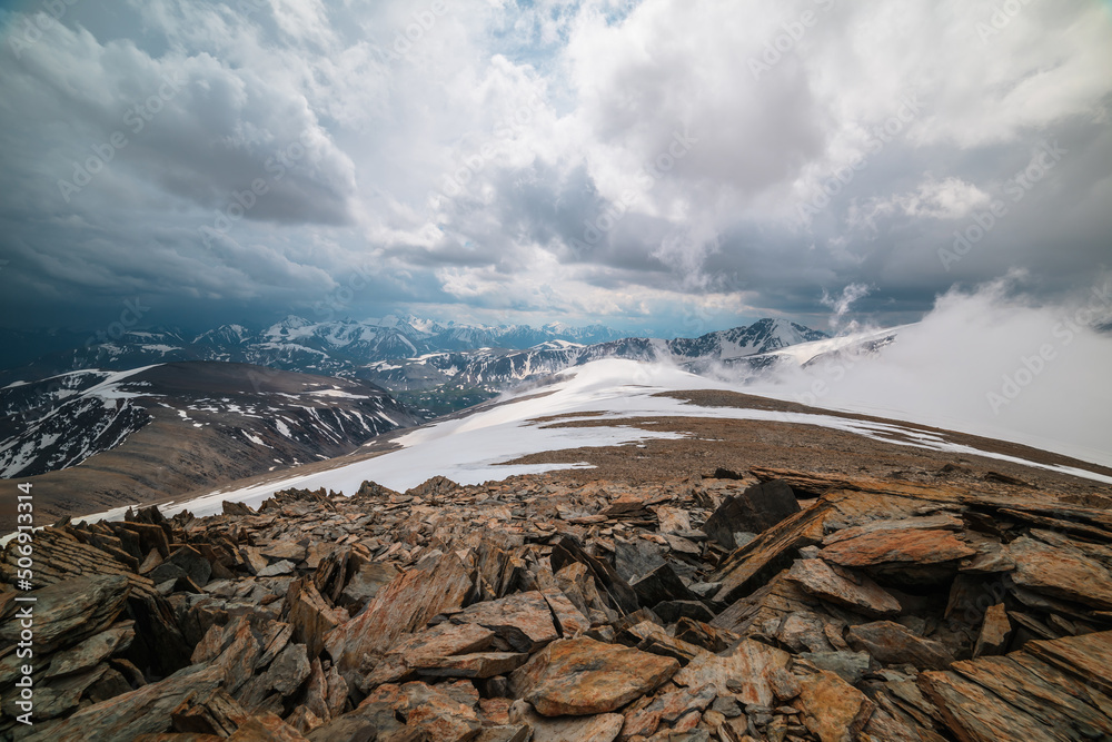 Awesome top view through clouds to high snowy mountains. Scenic ...