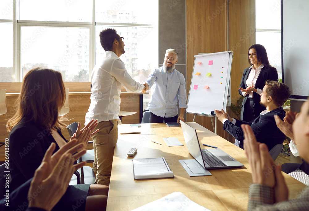 Middle-aged boss handshake excited male employee congratulate with job ...
