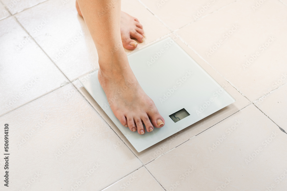 detail view of the feet of a latina woman, with one foot placed on the ...