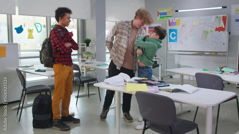 Students bullying boy in classroom. Teenage senior schoolboys bully and ...