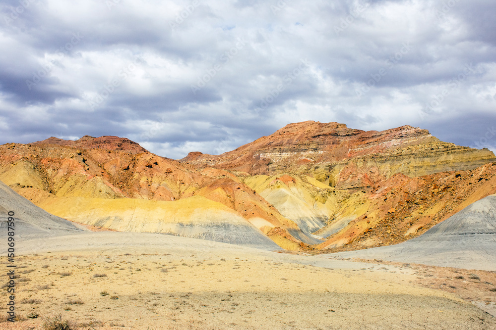 Multi-colored mountain made of yellow and orange mineralized soil and ...