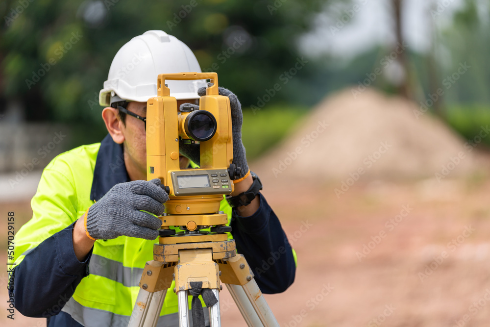 Surveyor Civil Engineer using equipment theodolite or total positioning ...