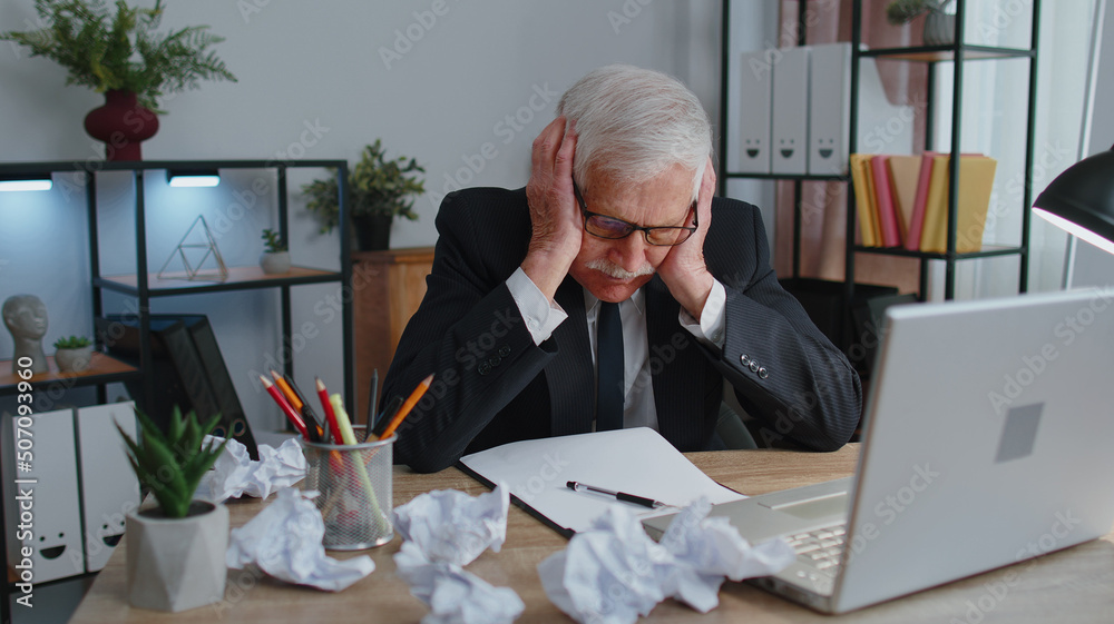 Senior business office man use laptop throwing crumpled paper, having ...