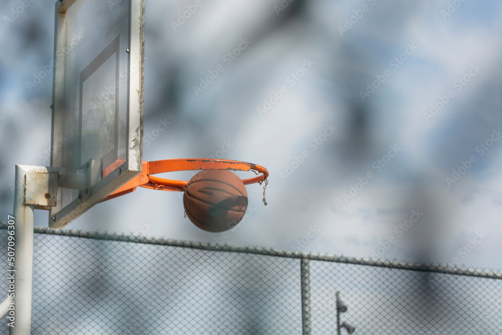 Basketball heading towards the hoop on an outdoor basketball court ...