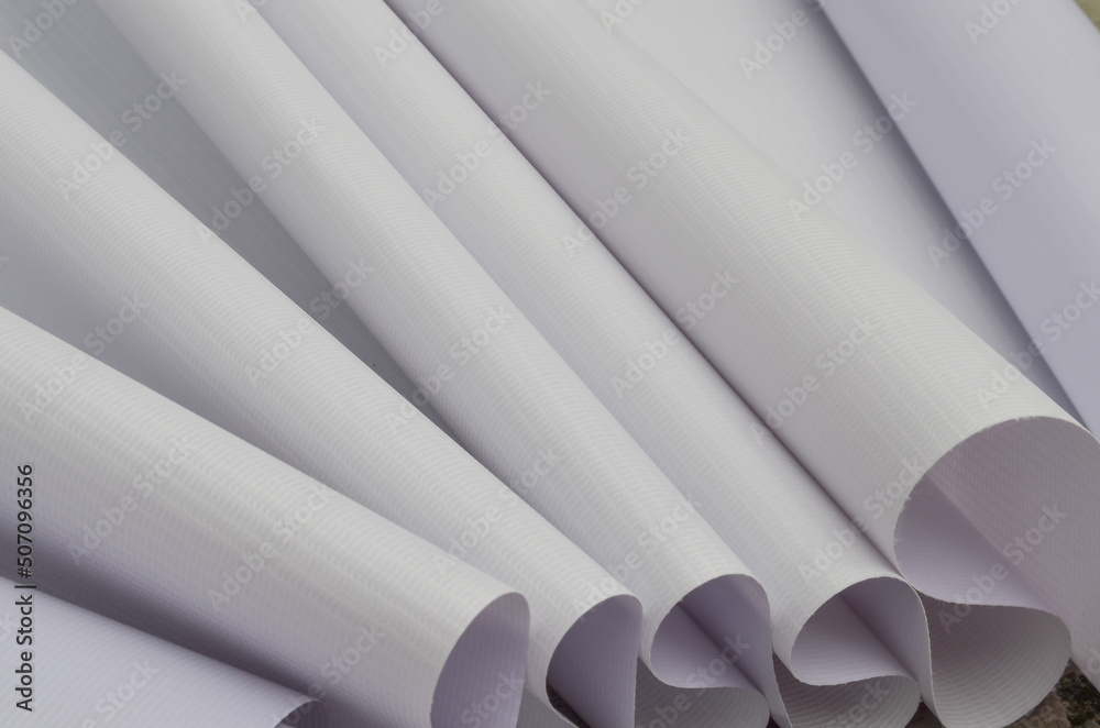 rolls of white flexible fabric. blank fabric sample with fibrous ...