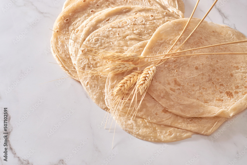 stack of homemade whole wheat flour tortillas on a marble table. Stock ...