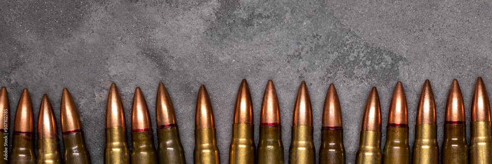 Bullets on gray background banner with copy space. Cartridges 7.62 ...