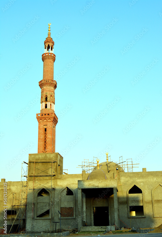 Poster A new mosque under construction against the sunny blue sky with ...