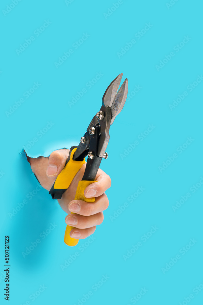 Man hand holding straight cut pliers suitable for cutting plastic or ...