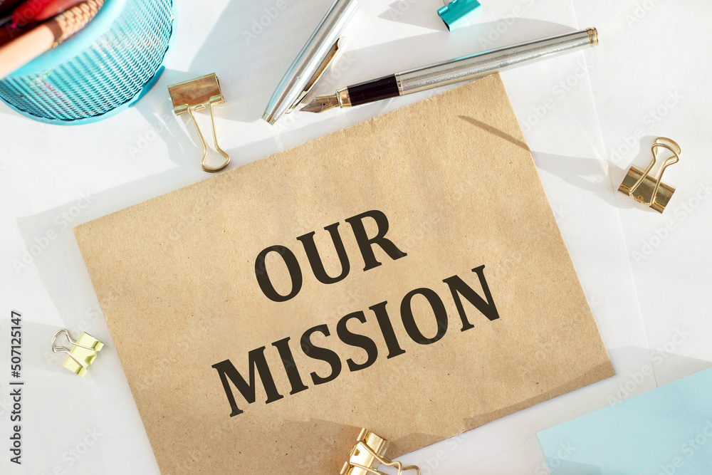 Envelope with office tools and text OUR MISSION on a white background ...