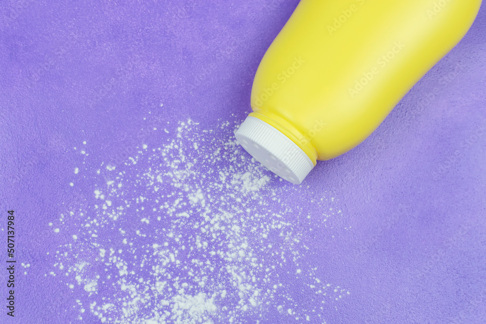 Children's background. Yellow bottle (jar) with baby powder on a lilac ...