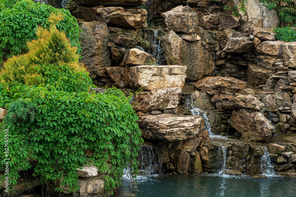 landscape design, a dam with a cascade of waterfalls in the form of ...