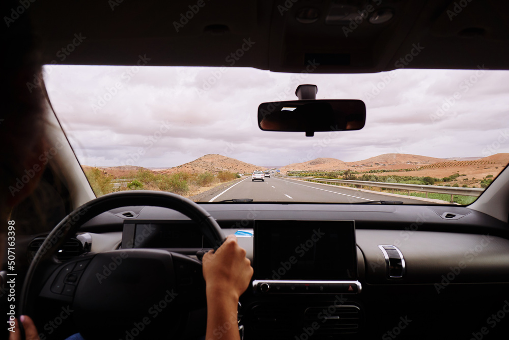 Driver driving a car on asphalt road. Stock Photo | Adobe Stock