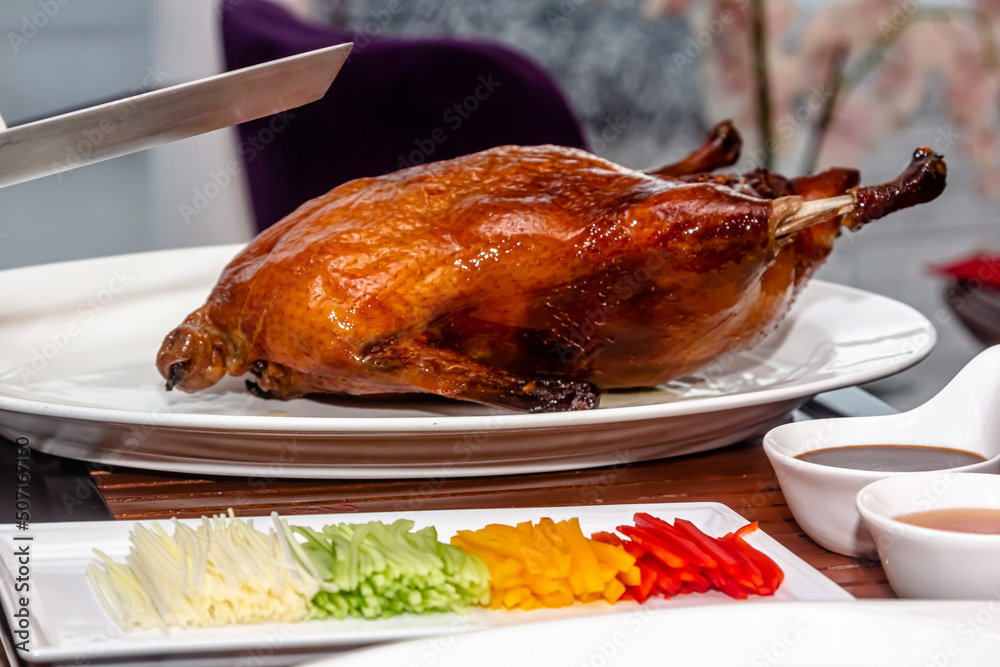 Chinese cook prepares beijing Roast Duck. Peking Duck is a famous duck ...