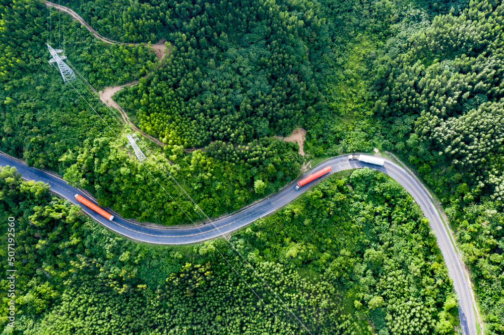 Transporting wind turbine propeller through curvy jungle road. Clean ...