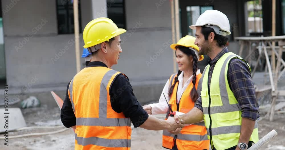 4K Slow side view . Civil engineer shakes hands and then looks around ...