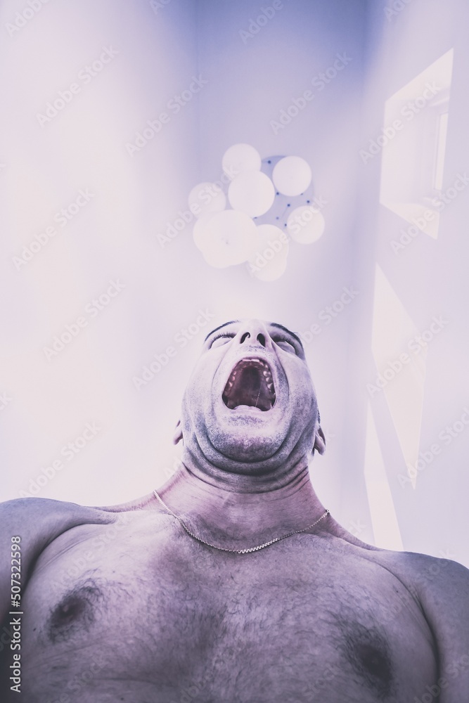 Crazy hairy chest man screaming and hawling at death with his mouth ...