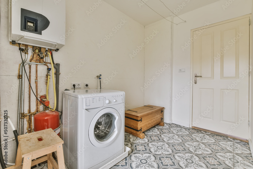 Washing machine and water heater in laundry room Stock Photo | Adobe Stock