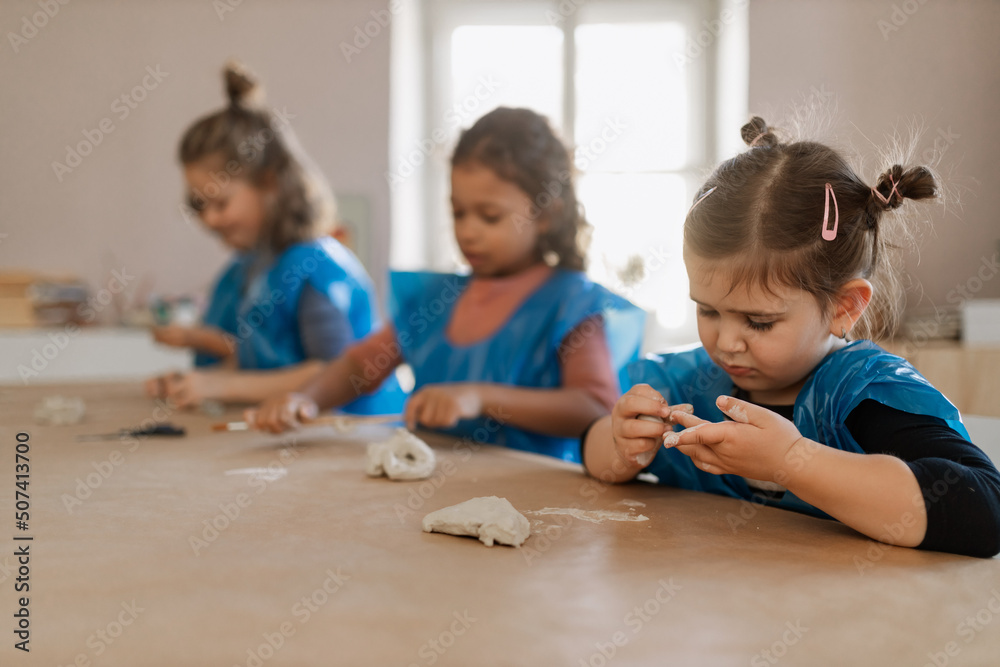 Group of little kids working with pottery clay during creative art and ...
