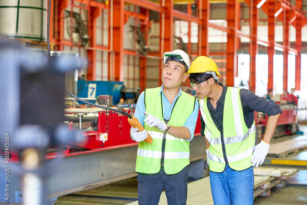 Two asian engineer working with lift remote control for lift up ...